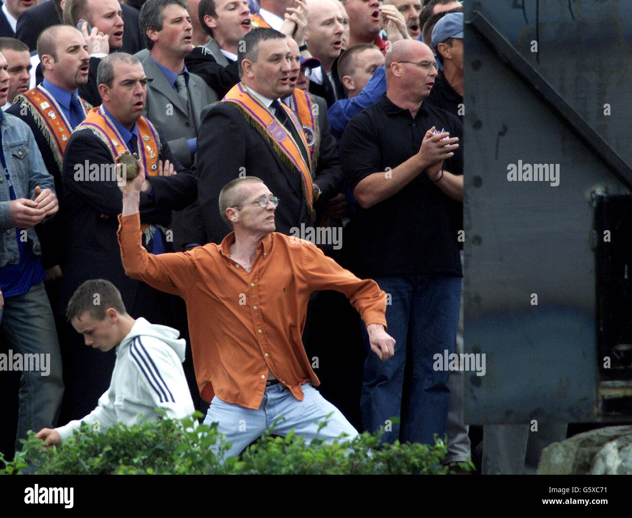 A man prepares to throw a brick at police as Portadown Orangemen clash ...