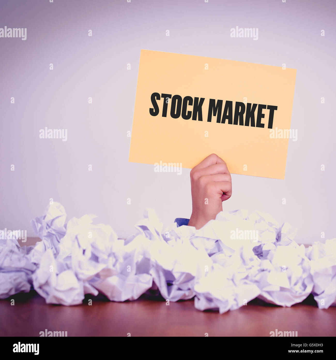 HAND HOLDING YELLOW PAPER WITH STOCK MARKETCONCEPT Stock Photo - Alamy