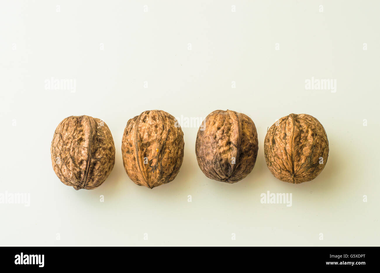 Walnuts in shell on a white background Stock Photo - Alamy