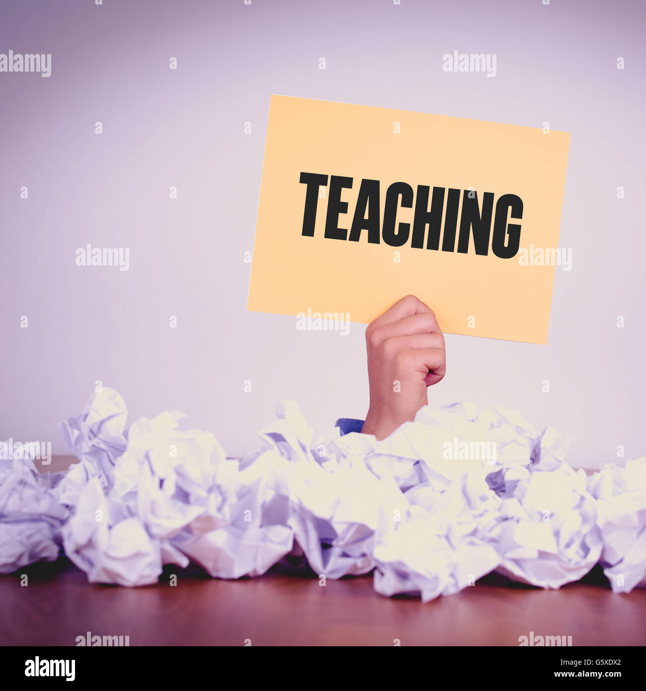 HAND HOLDING YELLOW PAPER WITH TEACHINGCONCEPT Stock Photo - Alamy