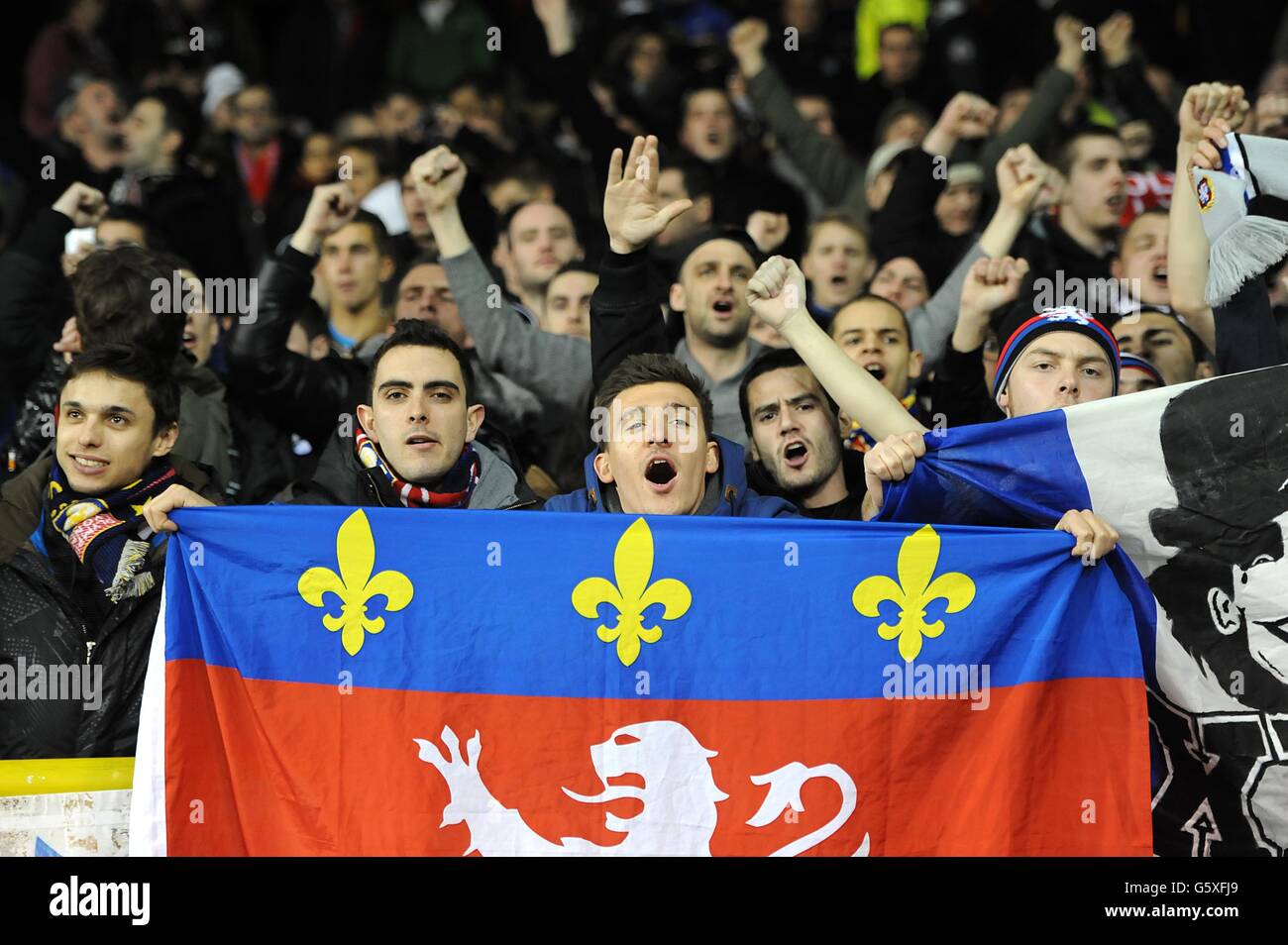 Lyon fans hold up flags in the stands hi-res stock photography and ...