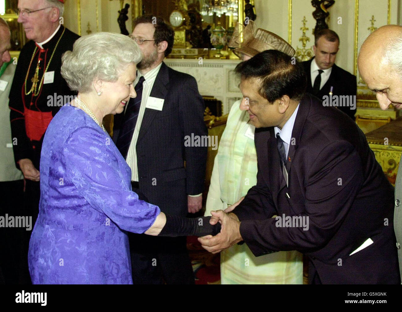 Queen Elizabeth II shakes hands with Mr Ratilal Chohan Chairman of the ...