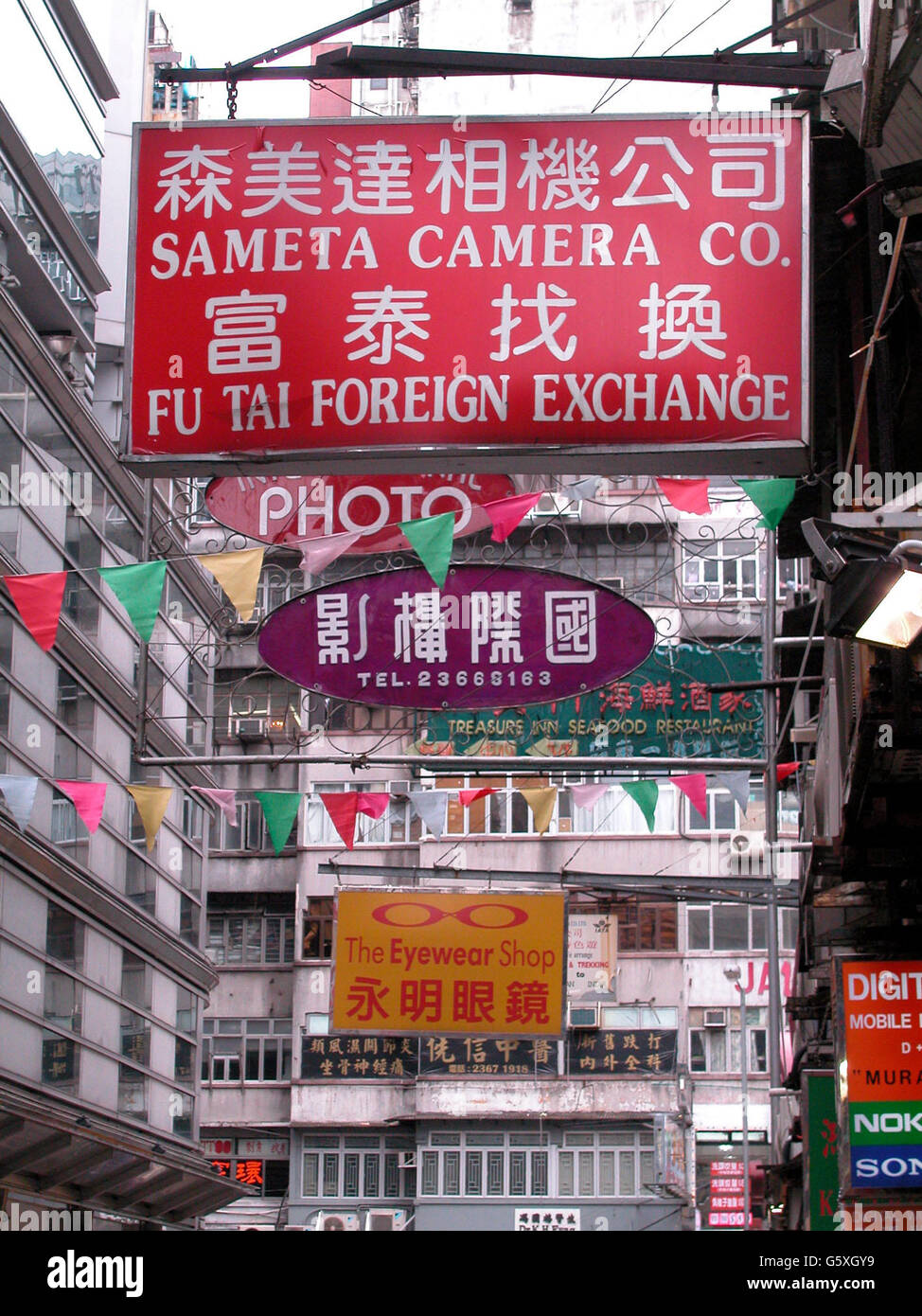 A sign hangs over the street offering a money exchange and a camera ...