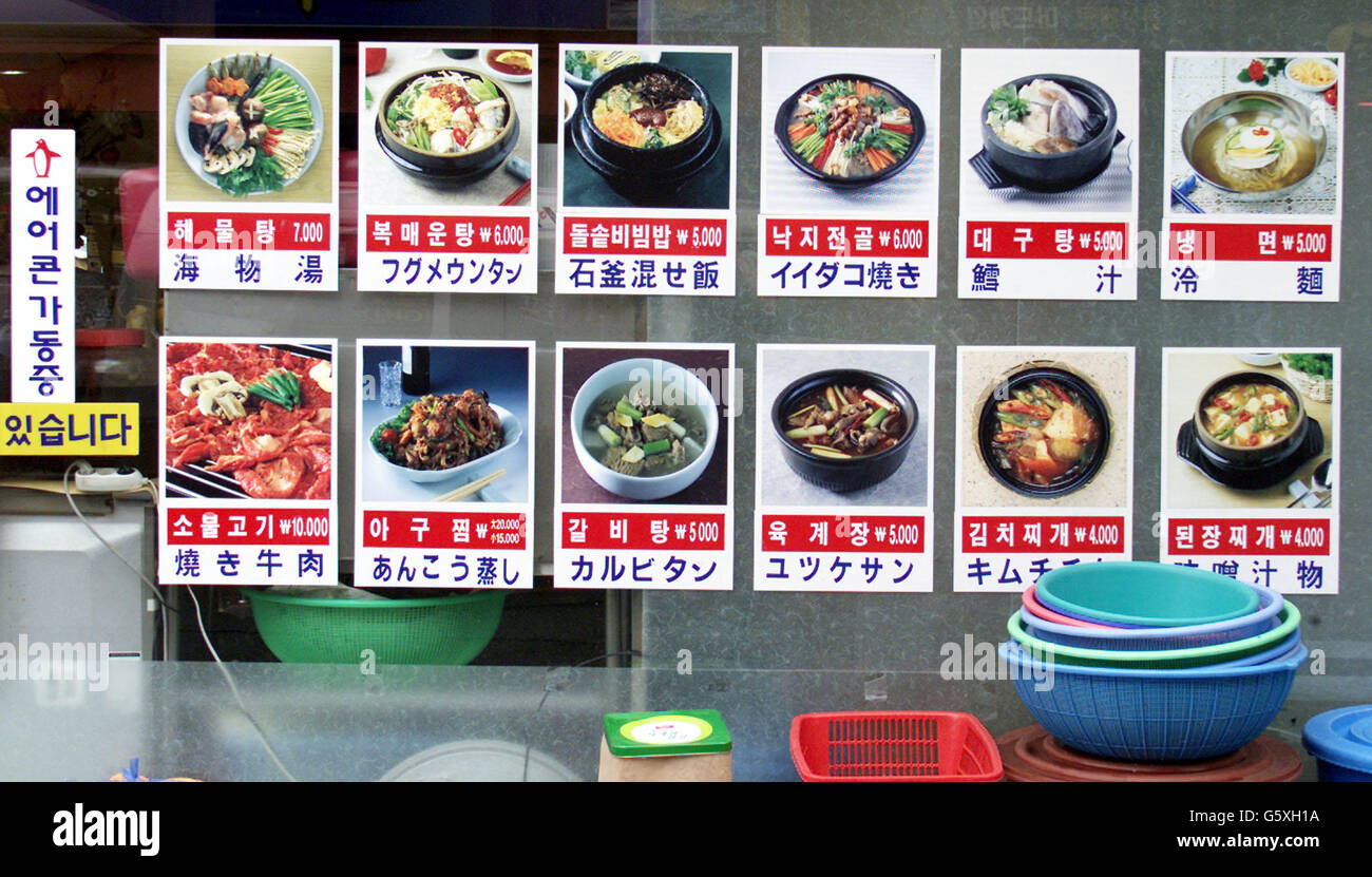 A restaurant window display varios dished on the menu to entice in ...