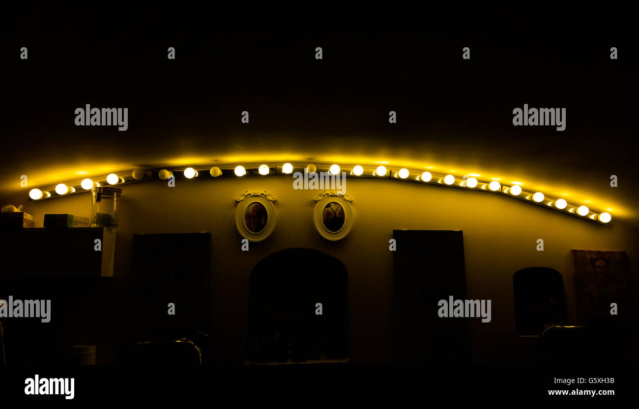 Front View of Light Bulbs in a Dark Room Stock Photo - Alamy