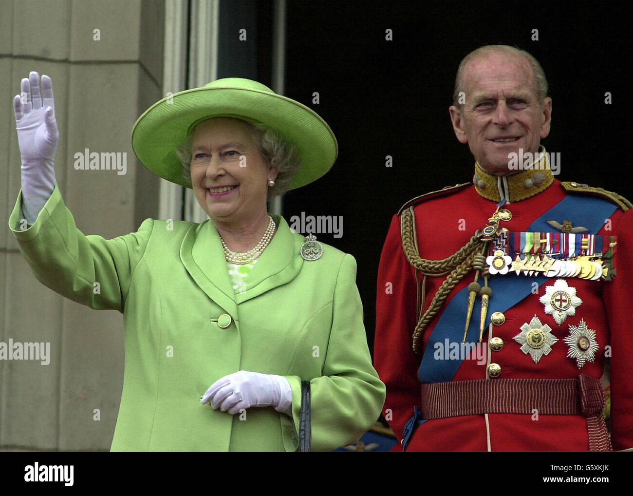 Britain's Queen Elizabeth II, with the Duke of Edinburgh, waves from ...