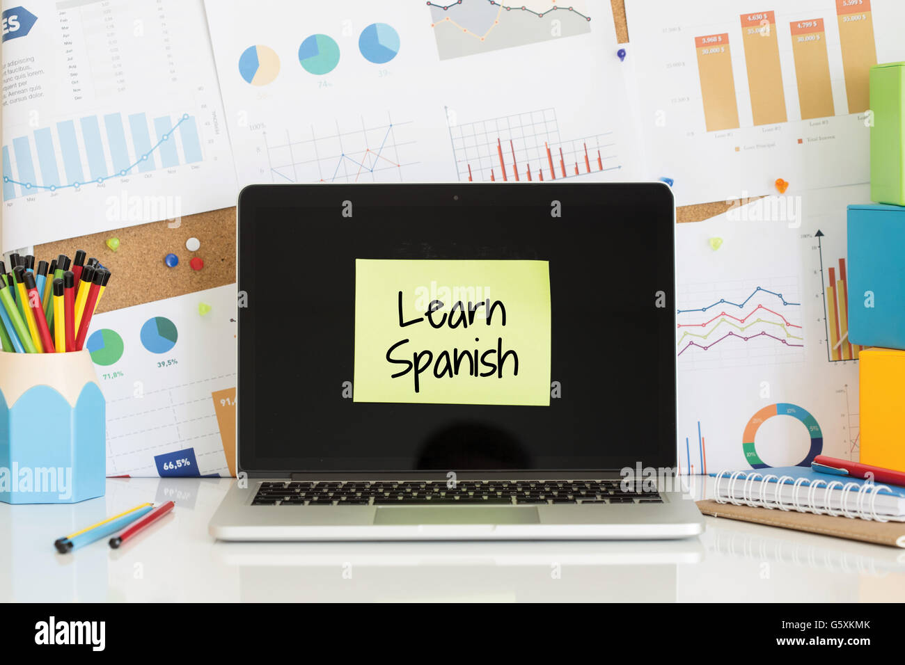 LEARN SPANISH sticky note pasted on the laptop screen Stock Photo - Alamy