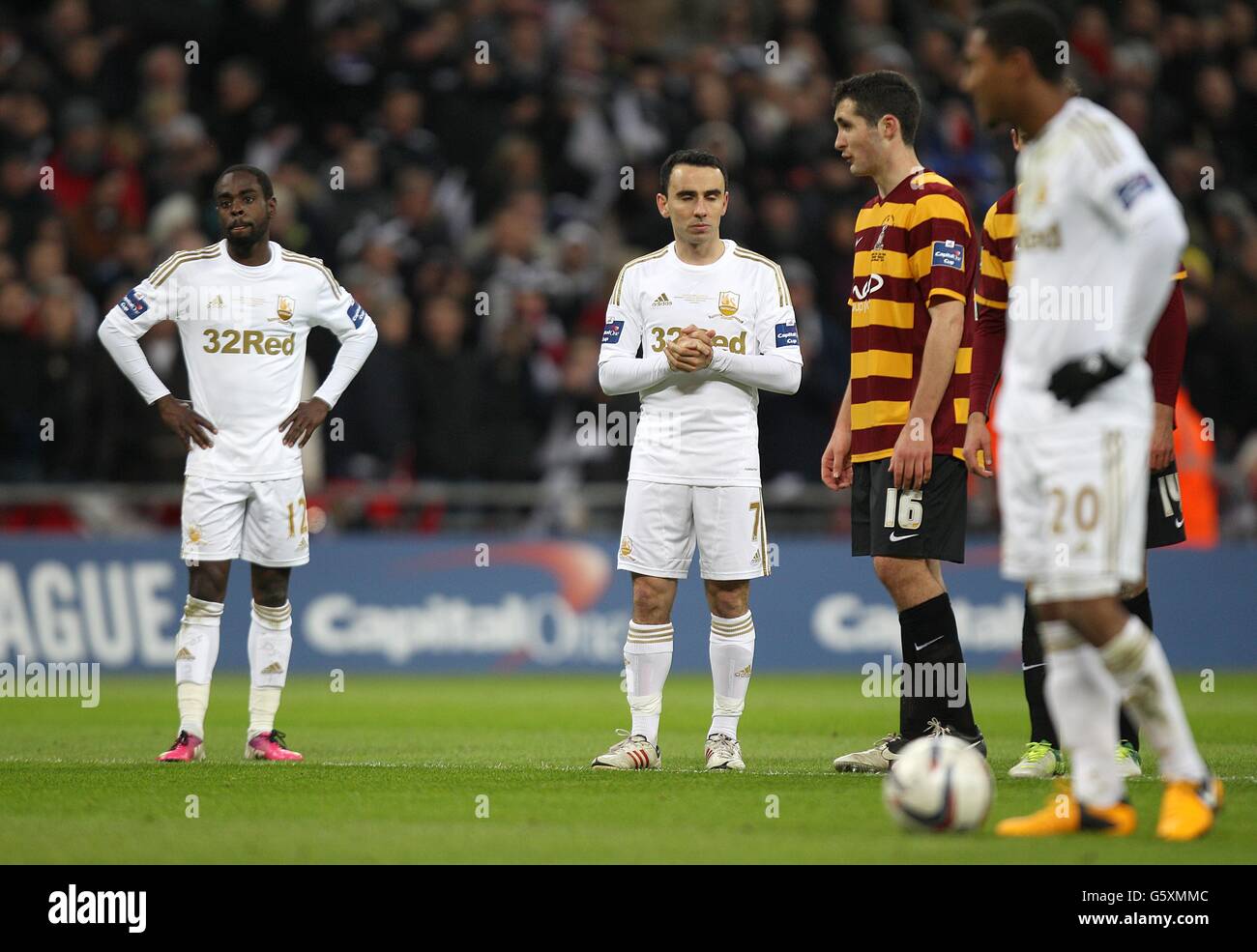 Swansea City's Jonathan De Guzman (right) waits to take a penalty as ...