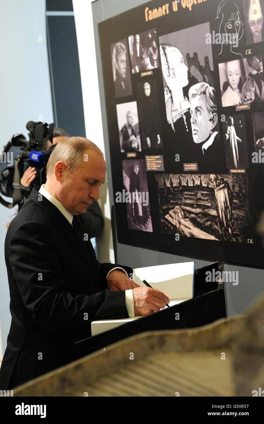 Russian President Vladimir Putin signs the guest book during a visit to ...