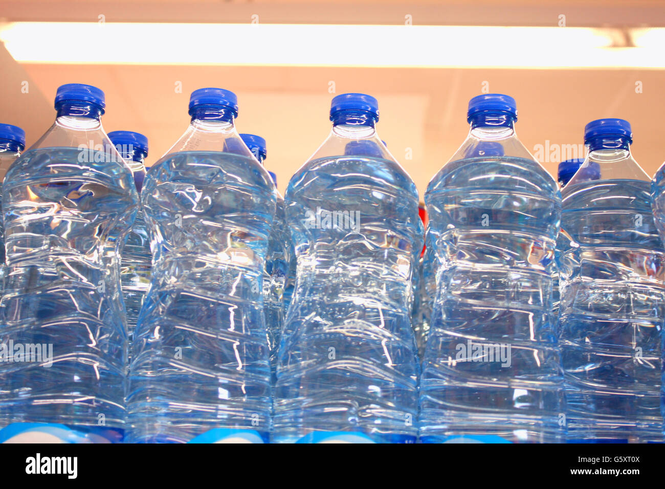 Rows of water bottles in store Stock Photo - Alamy