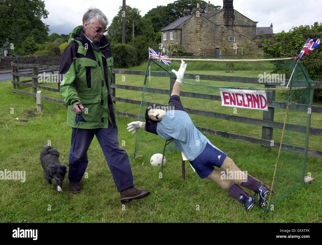A walker in Sawley, near Ripon, North Yorkshire, passes a scarecrow ...