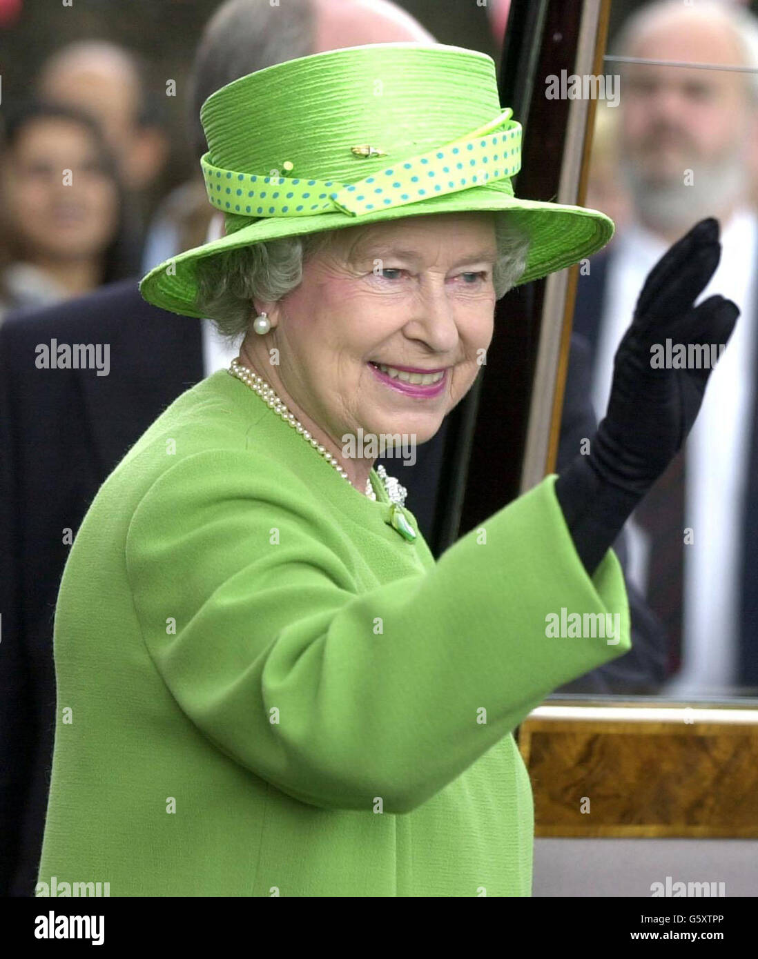 Britain's Queen Elizabeth II waves to the crowd as she arrives at the ...