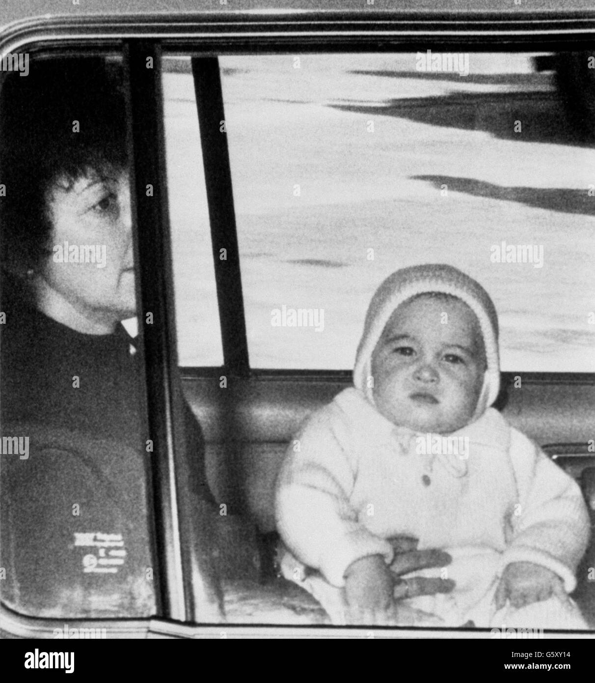 Prince William, aged eight months, on the knee of his nanny Barbara ...