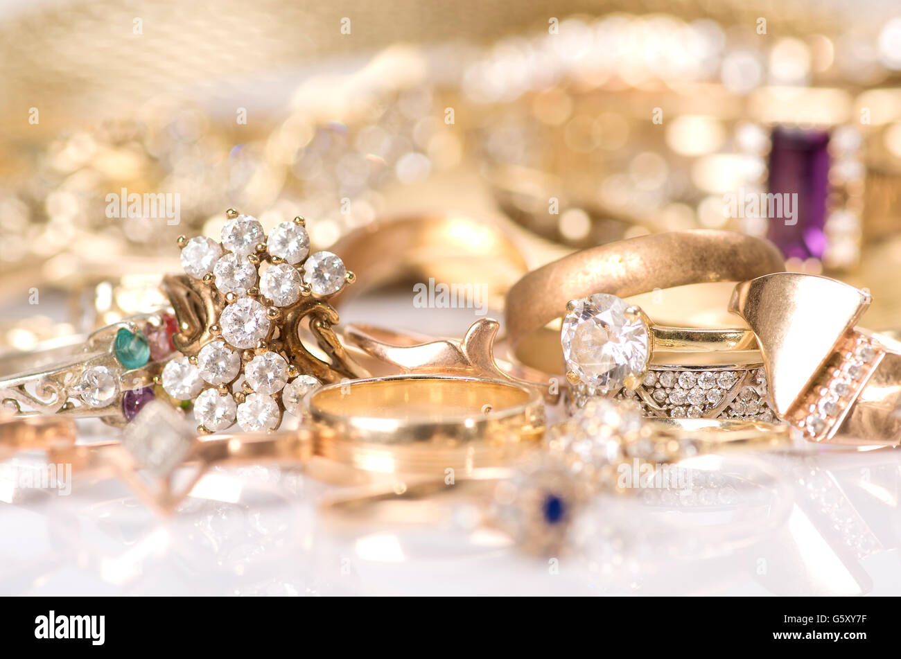 Gold jewelry on a white background Stock Photo - Alamy