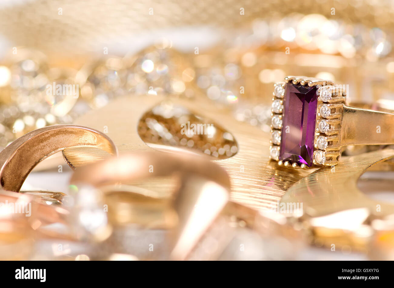 Gold jewelry on a white background Stock Photo - Alamy