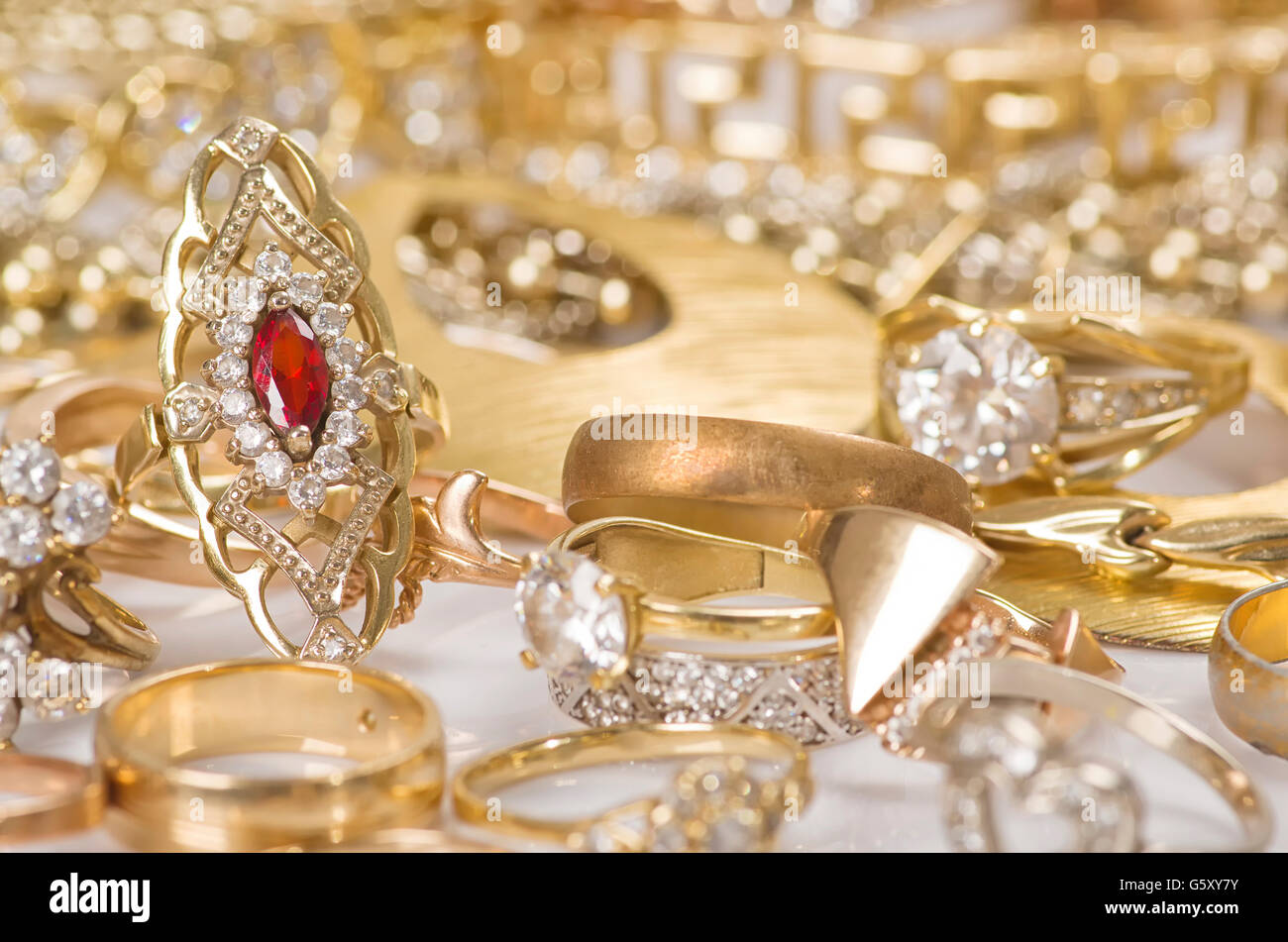 Gold jewelry on a white background Stock Photo - Alamy