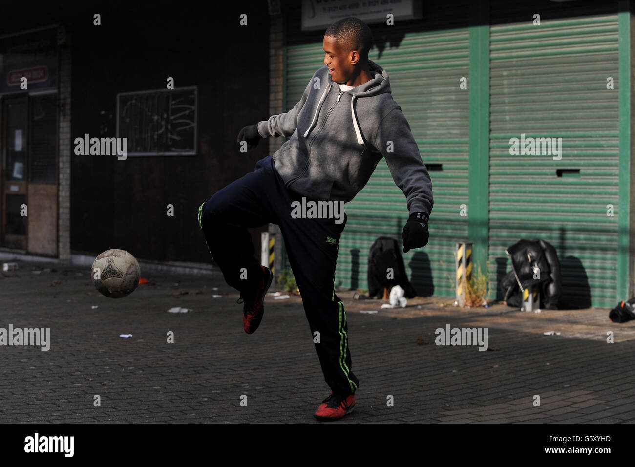 Youths play football on the streets of Ladywood, Birmingham which is ...