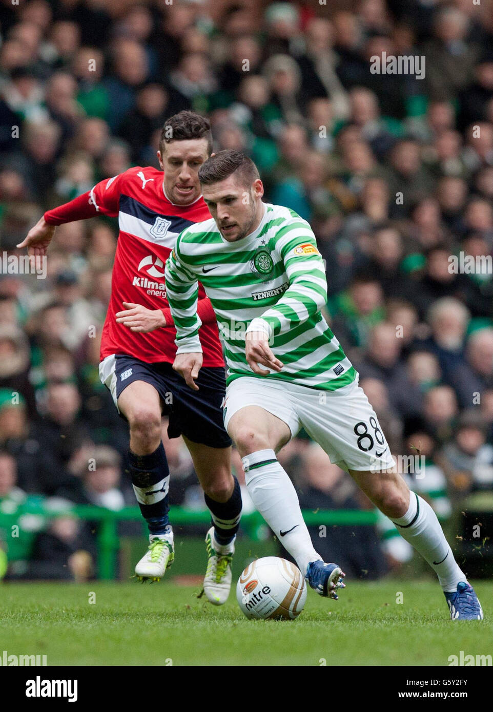Dundee's Ryan Conroy looks to tackle Celtic's Gary Hooper during the ...