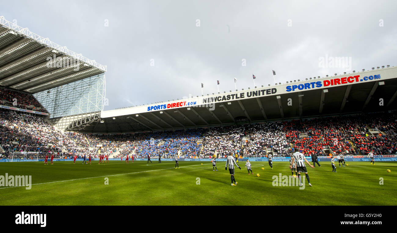 Newcastle United warm up before kick off with fans in the background ...