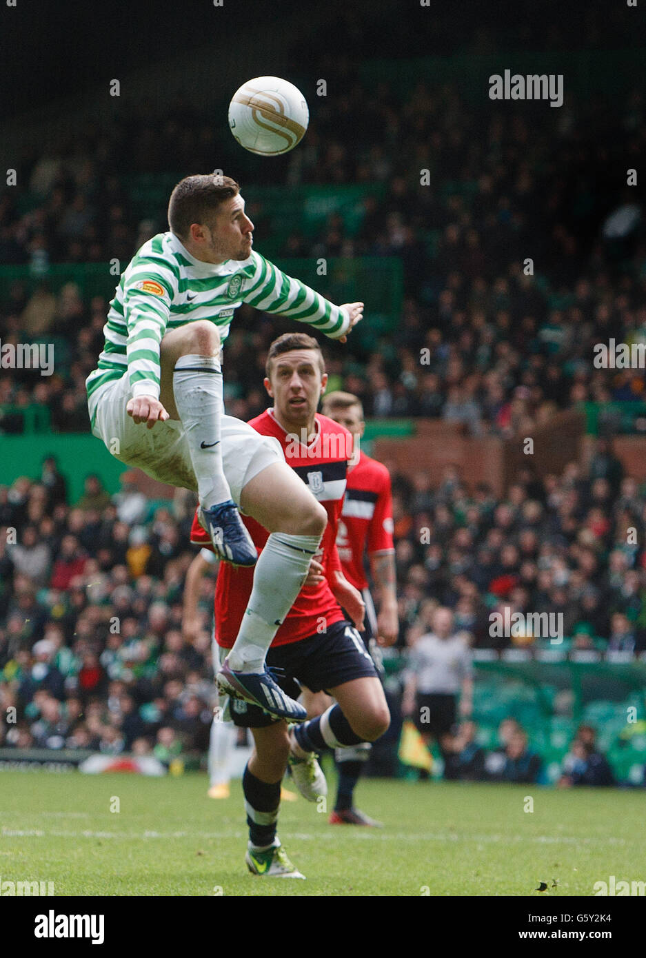 Celtics gary hooper leaps above dundees ryan conroy hi-res stock ...