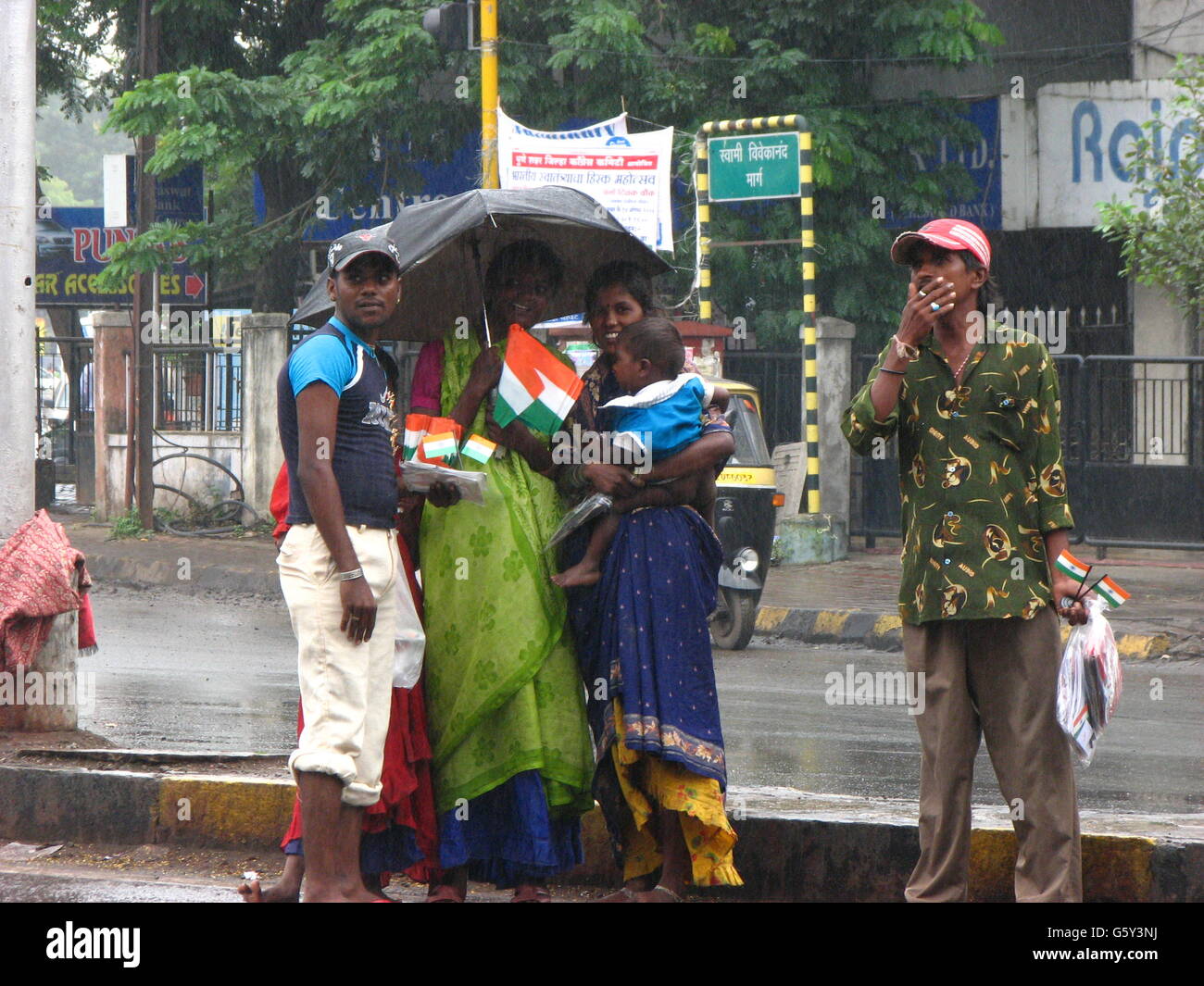 Poor people selling flags in rains on the eve of Indian Independence ...