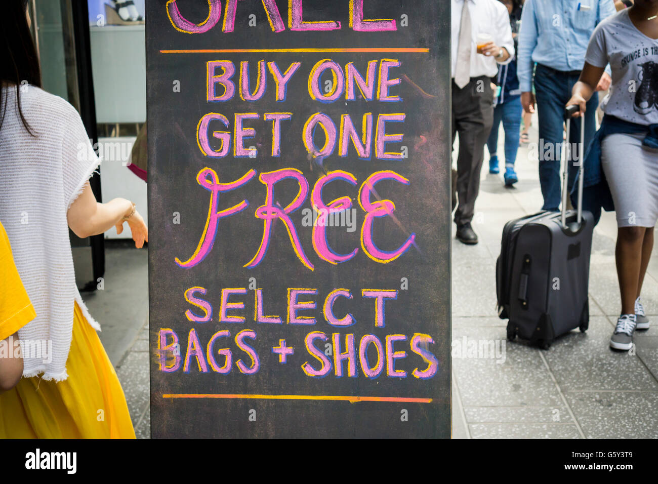 A "buy one, get one" promotion advertised outside of a clothing store ...