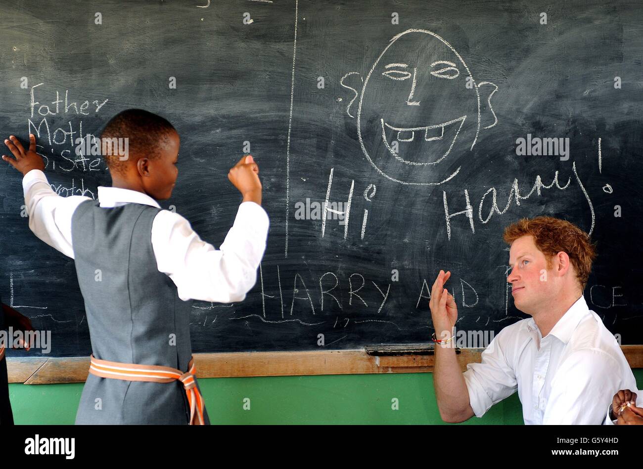 Prince Harry tries his hand at sign language in a class at the Kananelo ...
