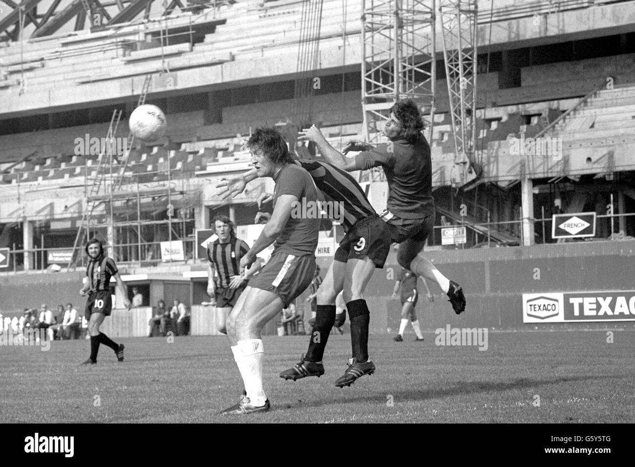 Chelsea goalkeeper Peter Bonetti (right) clears a high ball, aided by ...