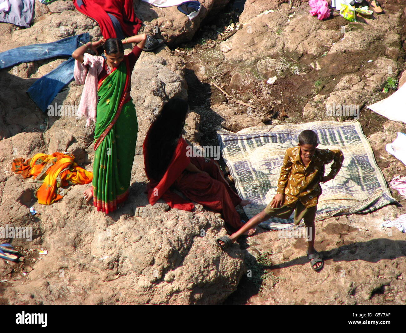 Indian Village folks standing on the rocks after washing their clothes ...