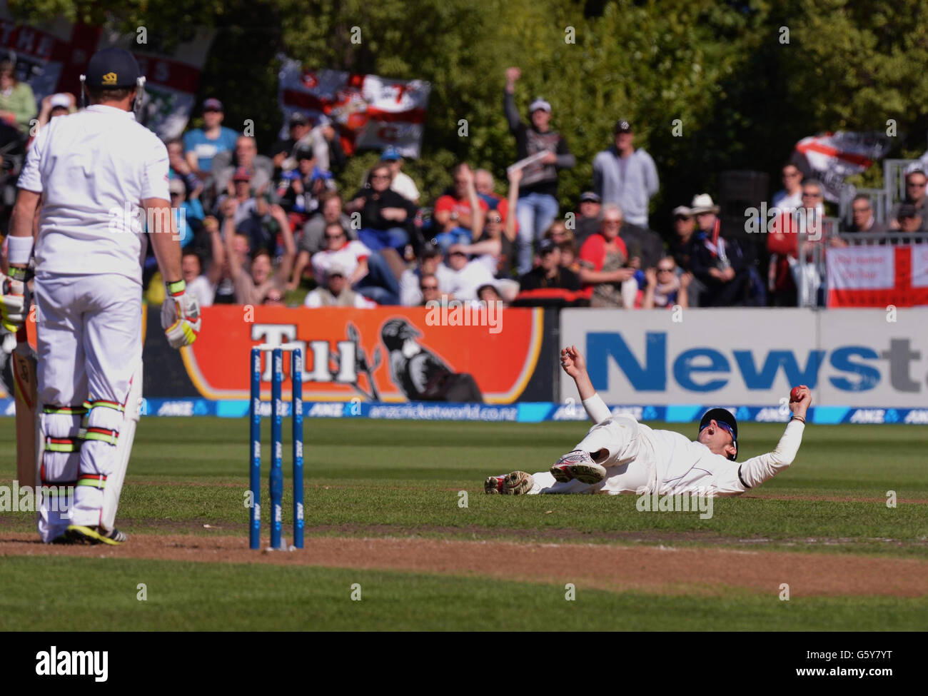 England's Ian Bell (left) looks on as New Zealand's Hamish Rutherford ...