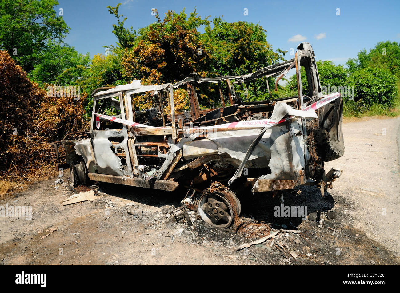Burnt out motor vehicle at the roadside Stock Photo - Alamy