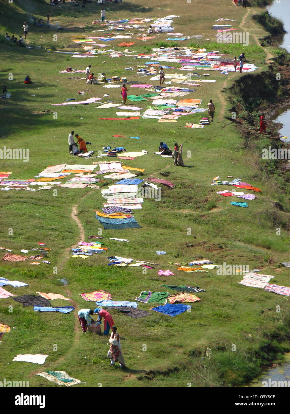 Poor people drying their laundry on a riverbank in India Stock Photo ...