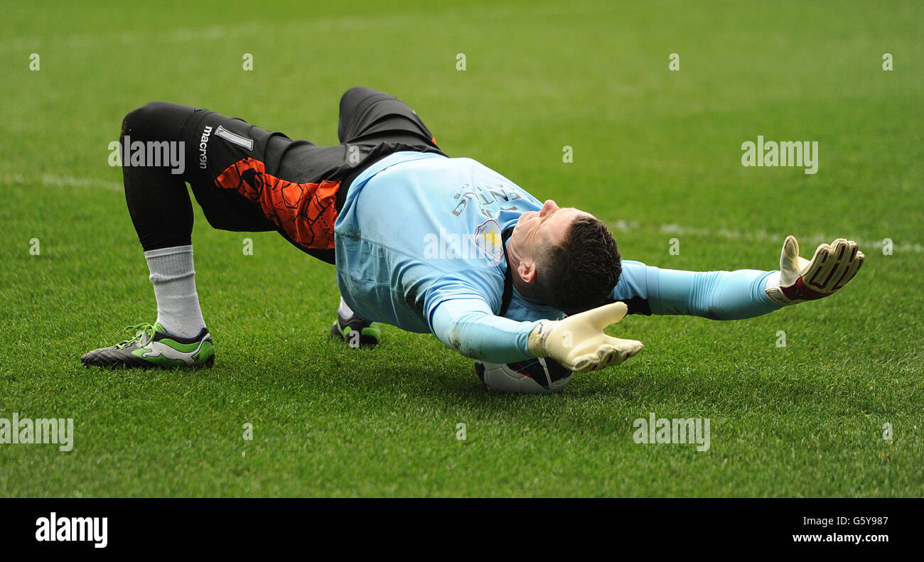 Aston Villa goalkeeper Shay Given uses a football to aid his stretches ...