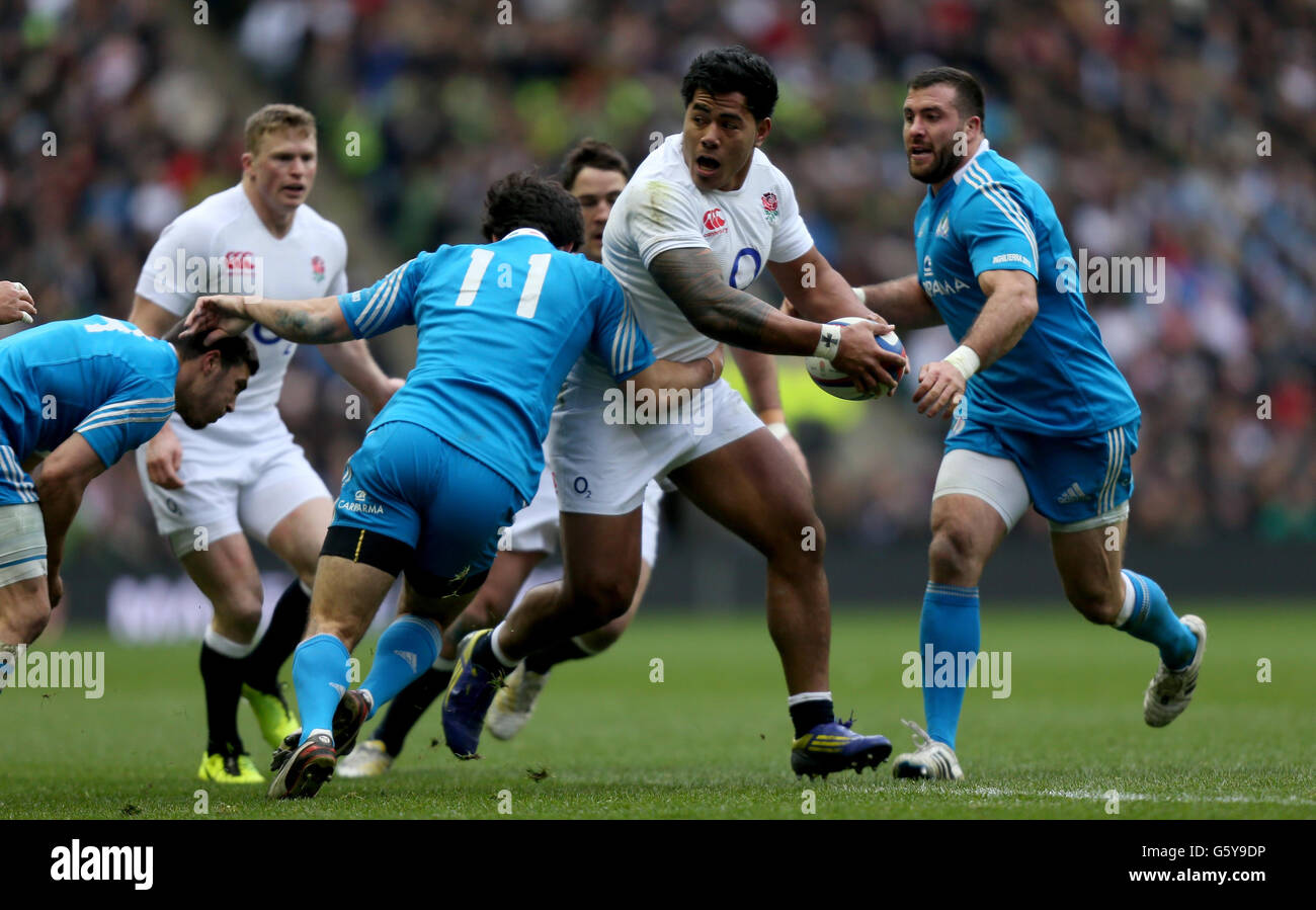 England's Manu Tuilagi (centre right) is tackled by Italy's Luke McLean ...