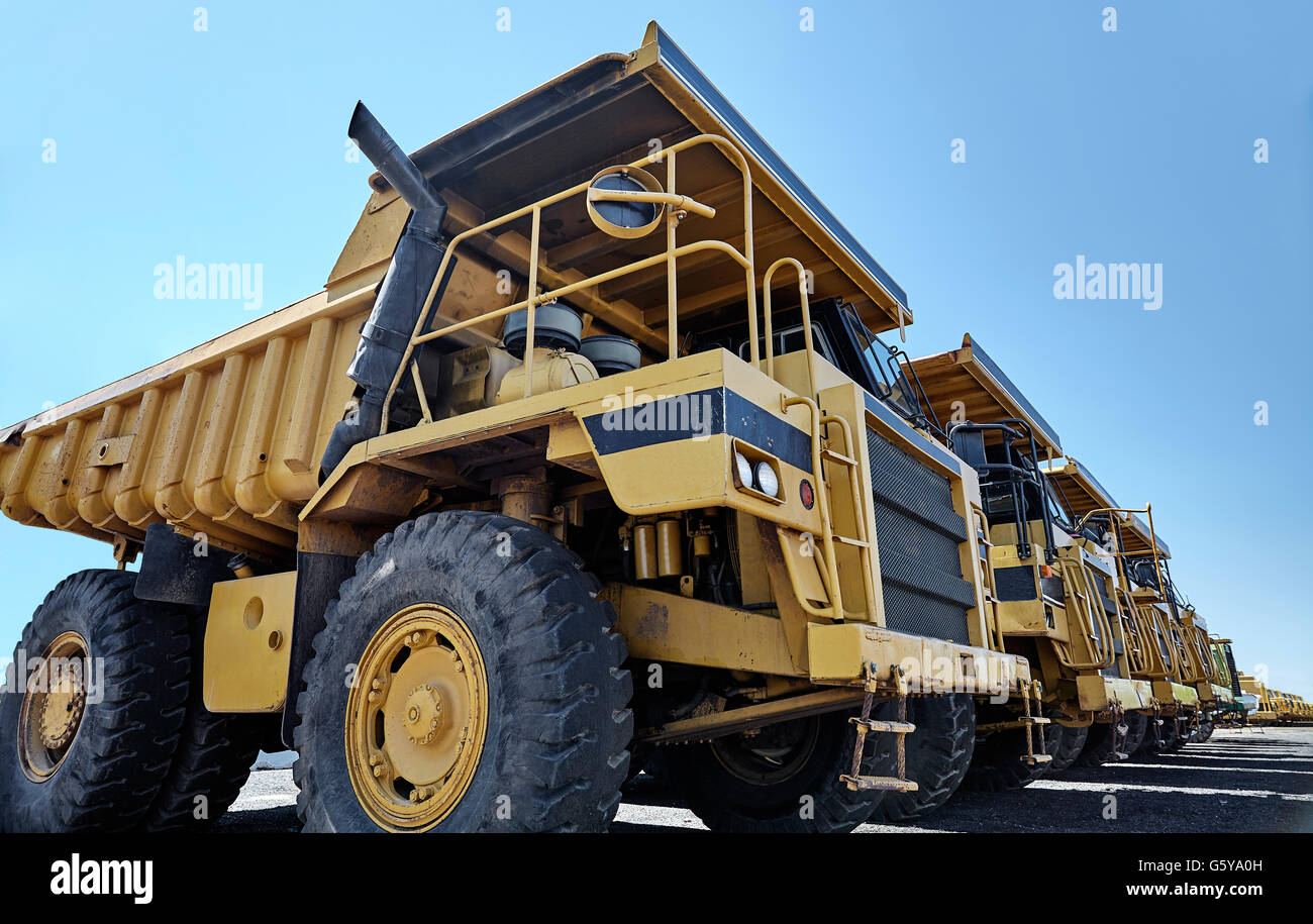 Heavy equipment row industrial mining dump trucks Stock Photo - Alamy