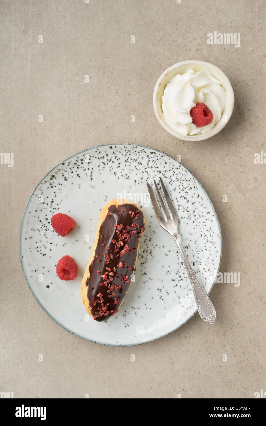 Chocolate raspberry eclair Stock Photo - Alamy
