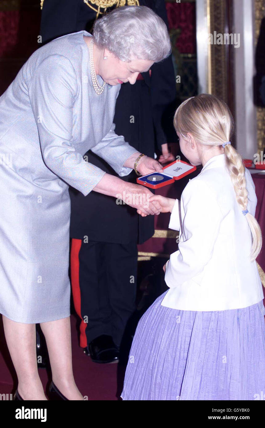 Queen Elizabeth II presenting a silver medal to Louise Shaw, aged 8 ...