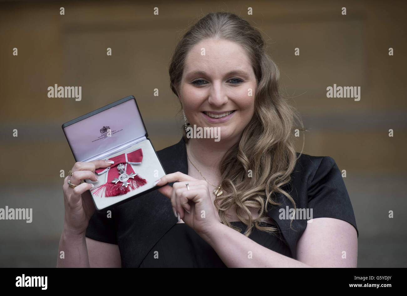 Heather Frederiksen proudly holds her MBE award after the Investiture ...