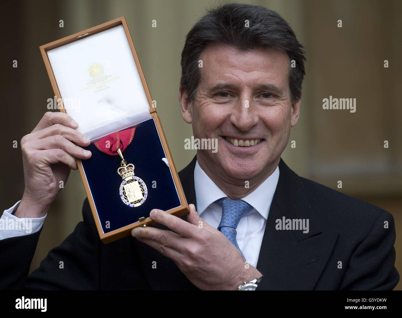 Lord Sebastian Coe proudly holds his Companions of Honour award after ...