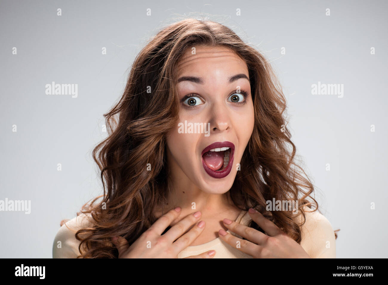 Portrait of young woman with shocked facial expression Stock Photo - Alamy