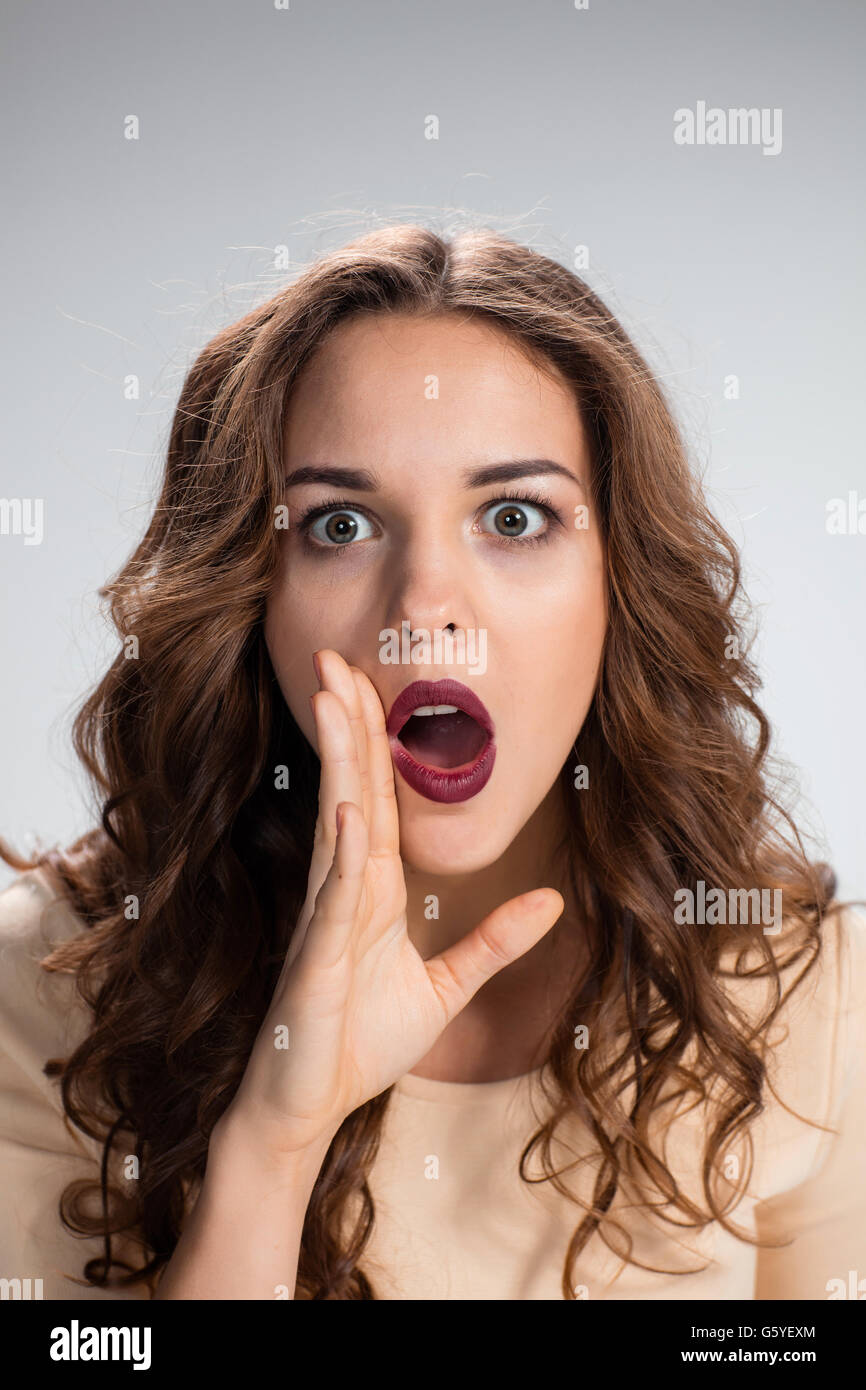 Portrait of young woman with shocked facial expression Stock Photo - Alamy