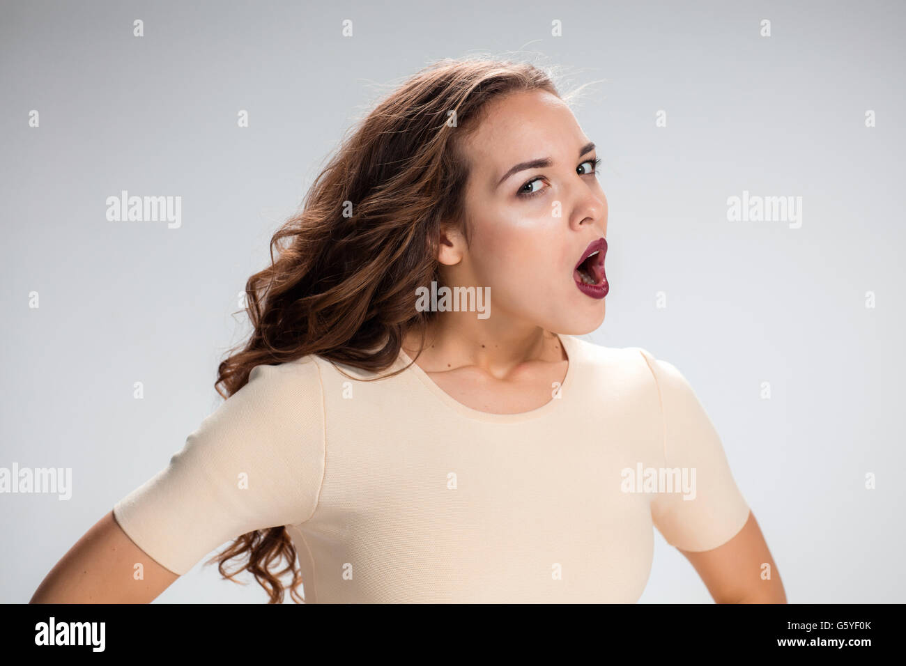 Portrait of young woman with shocked facial expression Stock Photo - Alamy