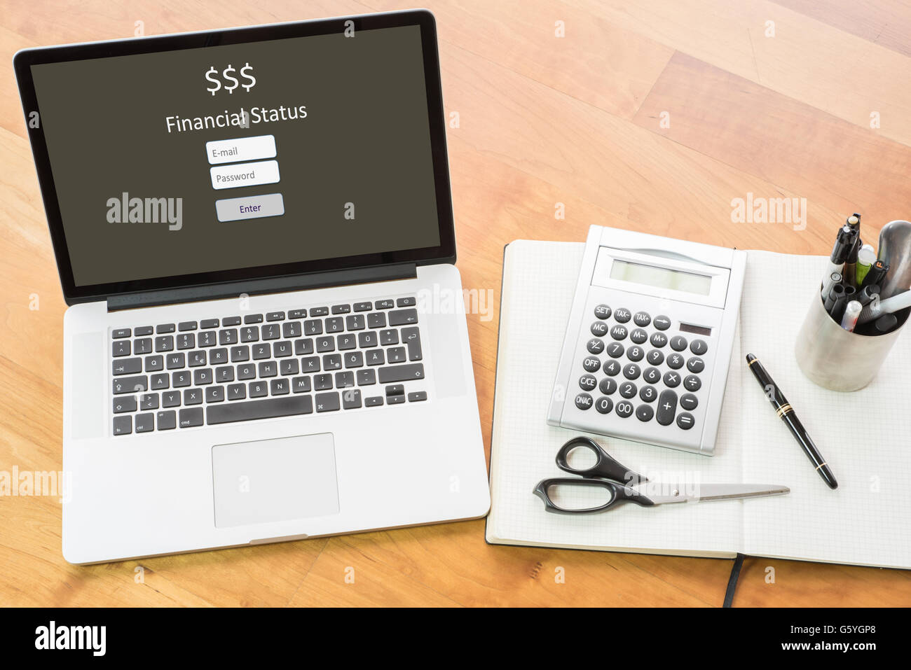 wooden desk with computer and notebook - login financial status Stock ...