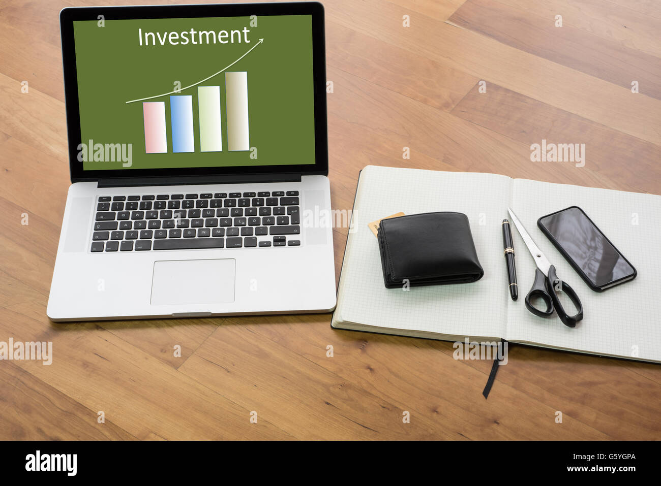 wooden desk with computer and notebook - chart Investment Stock Photo ...