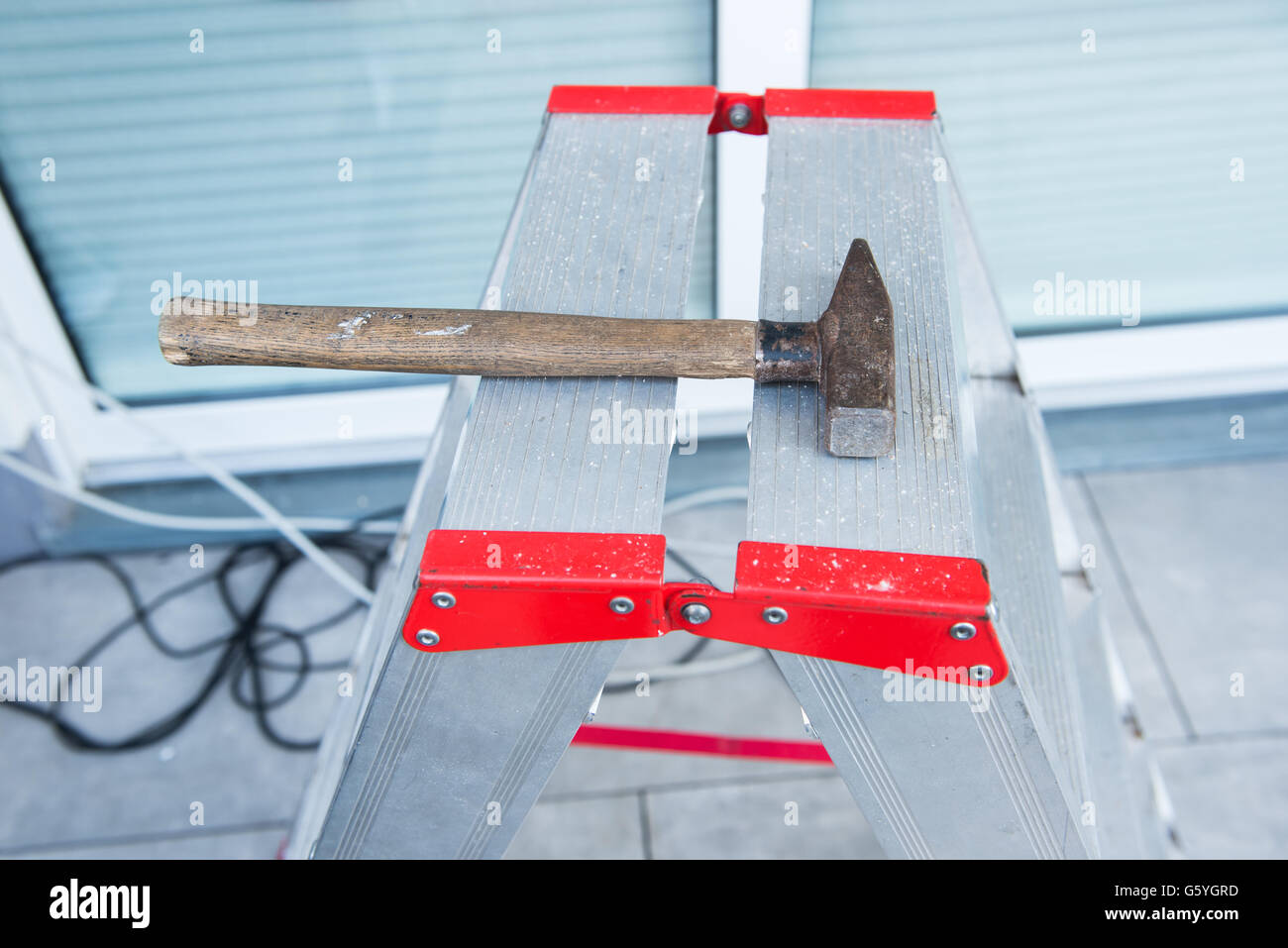 heavy duty hammer lying on professional aliuminium ladder Stock Photo ...