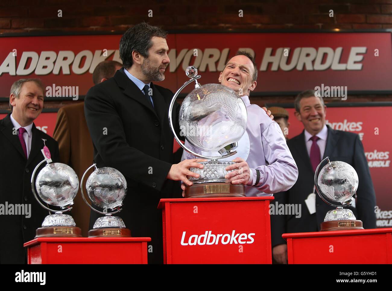 Jockey Paul Carberry (right) celebrates winning the Ladbrokes World ...