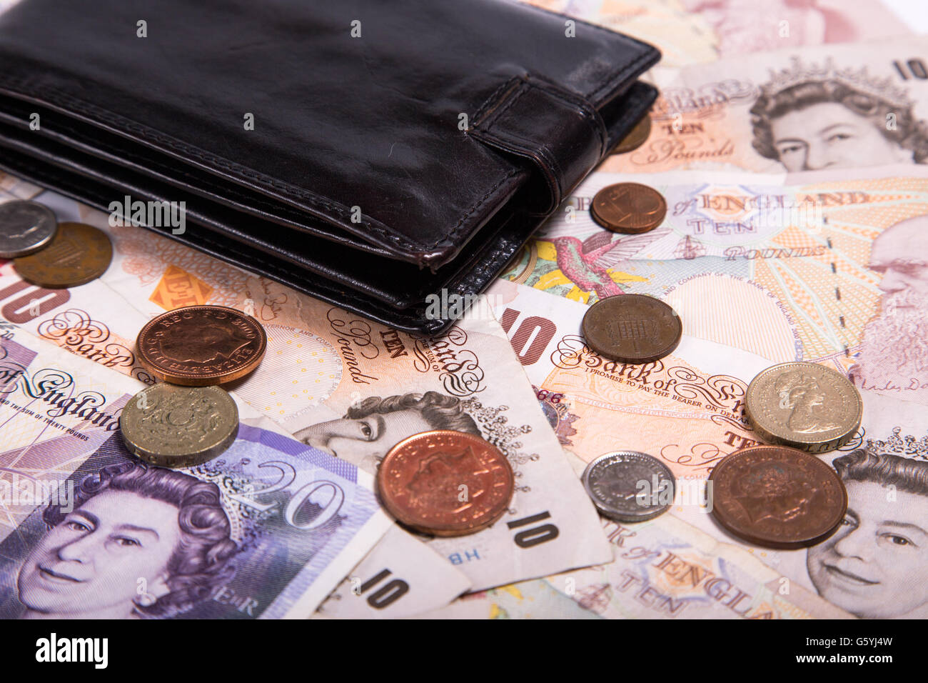 Pound money and black wallet background Stock Photo - Alamy