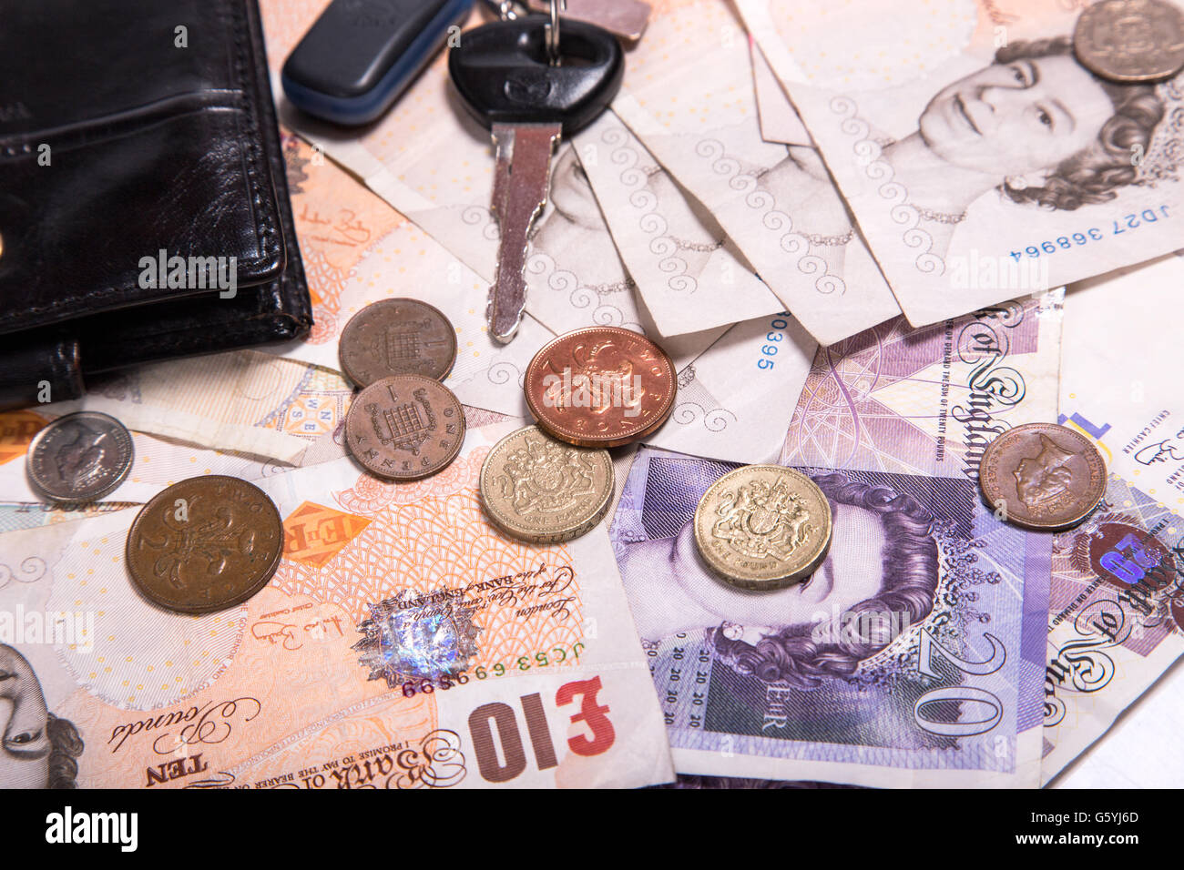 Pound money and black wallet background Stock Photo - Alamy
