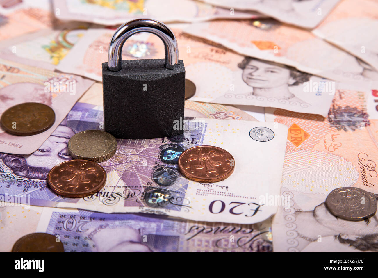 A close-up photograph of Sterling currency and padlock Stock Photo - Alamy