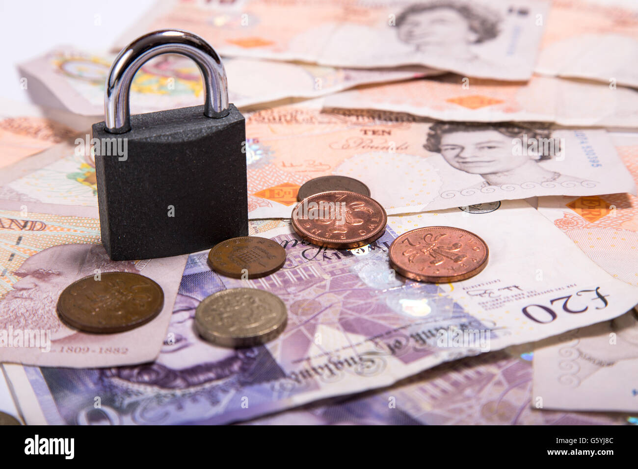 A close-up photograph of Sterling currency and padlock Stock Photo - Alamy